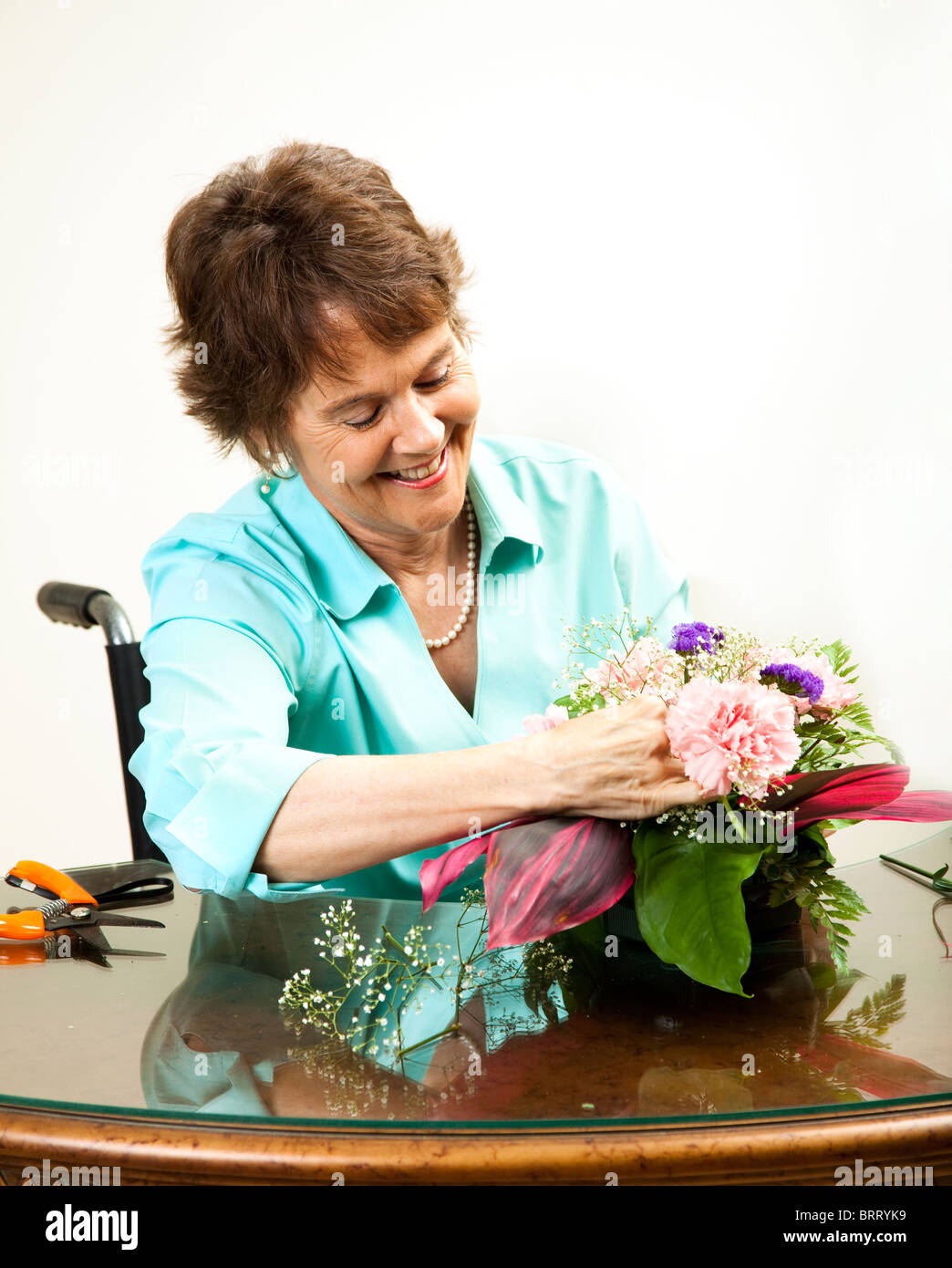 Pretty disabled woman arranging a bouquet of flowers Stock Photo - Alamy