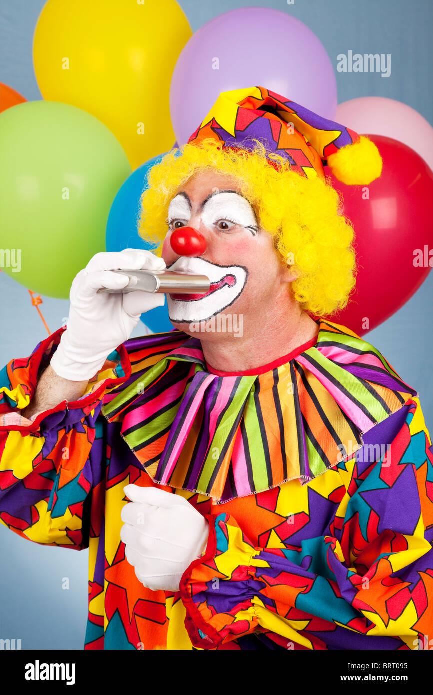 Alcoholic clown takes a drink from his flask Stock Photo - Alamy