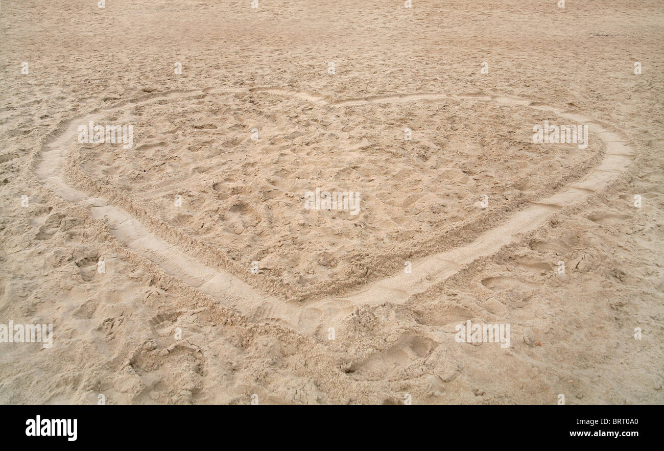 a heart shape carved in the beach sand Stock Photo - Alamy