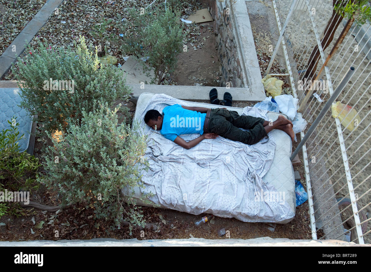 Homeless African refugee sleeps in park in Eilat Israel Stock Photo - Alamy