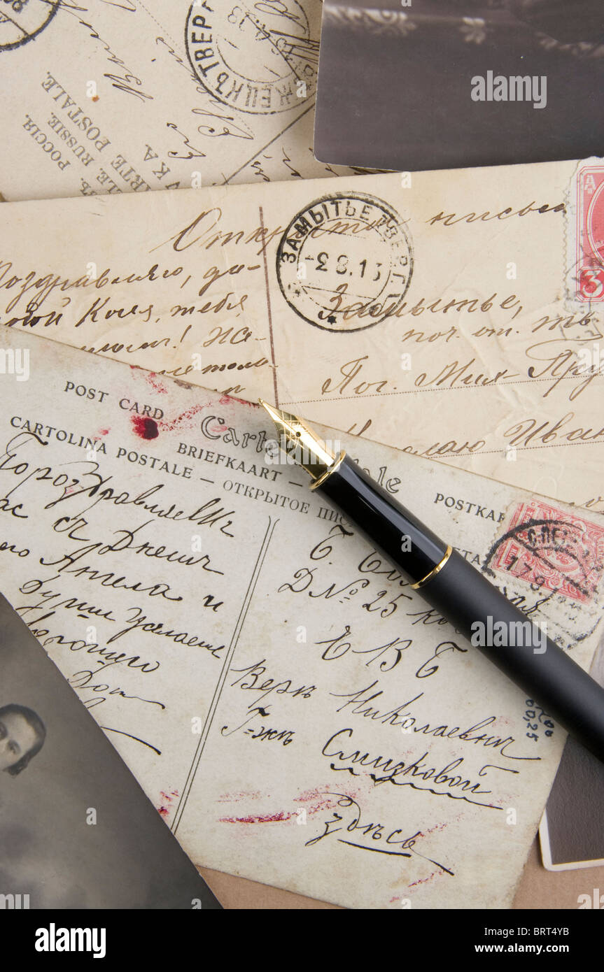 Retro postcards and gold pen Stock Photo - Alamy