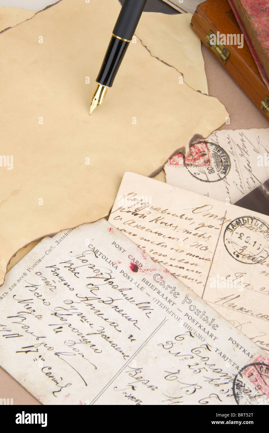 Retro postcards and gold pen Stock Photo - Alamy