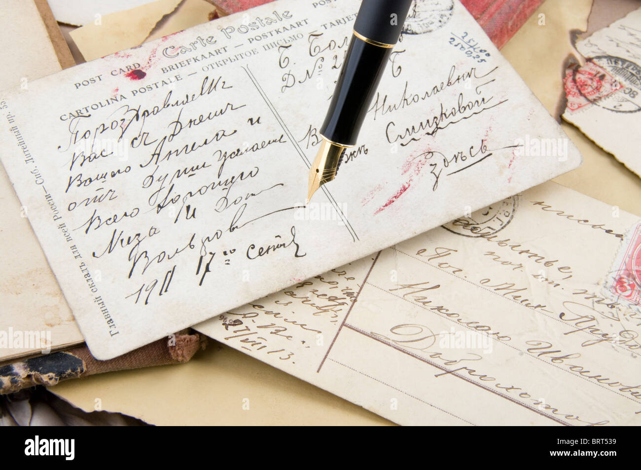 Retro postcards and gold pen Stock Photo - Alamy