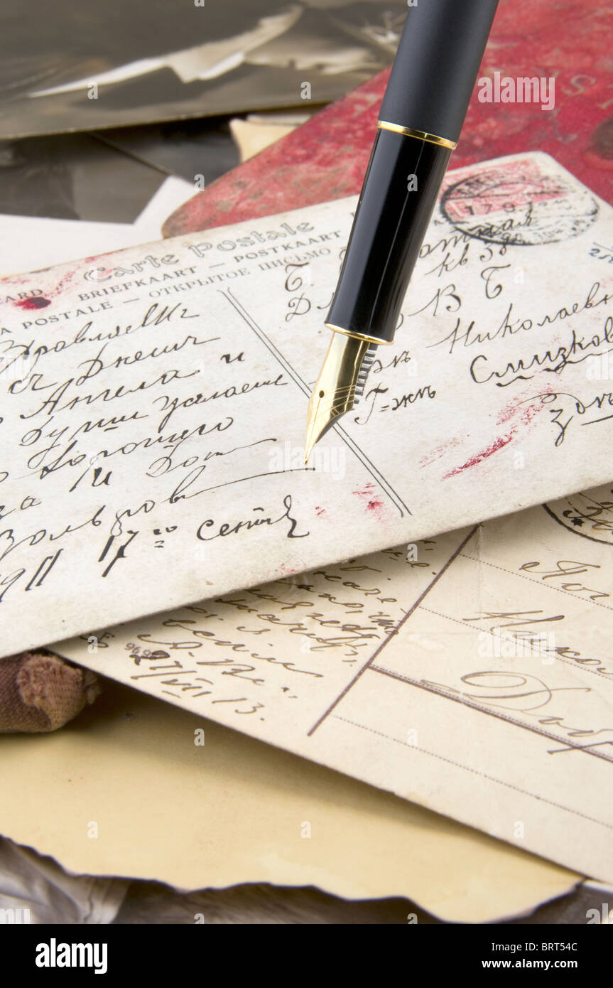 Retro postcards and gold pen Stock Photo - Alamy