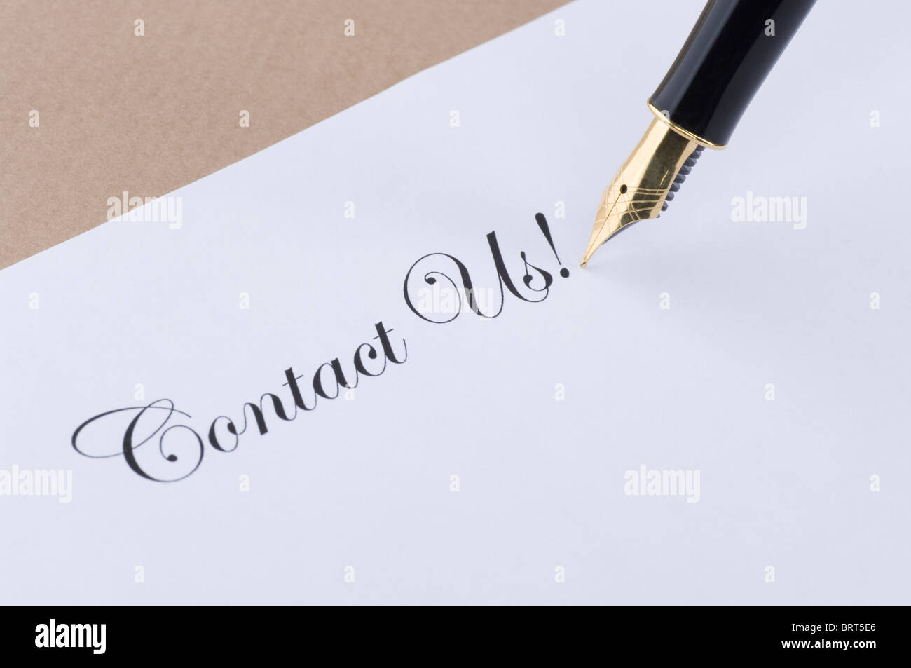 Inscription Contact us with gold pen Stock Photo - Alamy