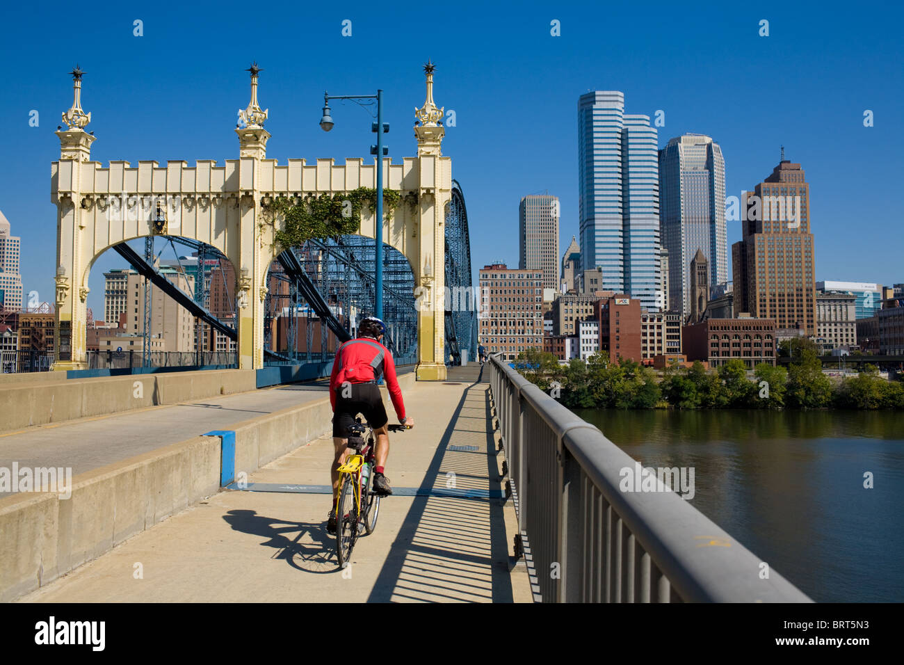 Biker crossing Smithfield Street Bridge over Monongahela River ...