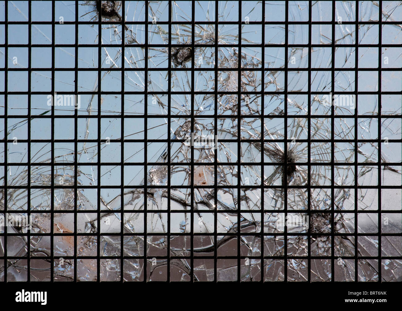 Broken glass window with square grid Stock Photo - Alamy
