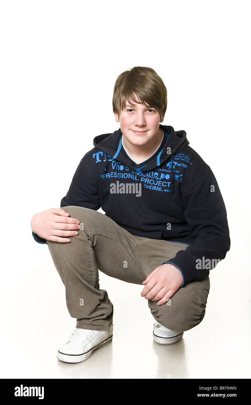 Full-length portrait of crouching teenage a boy isolated on white ...