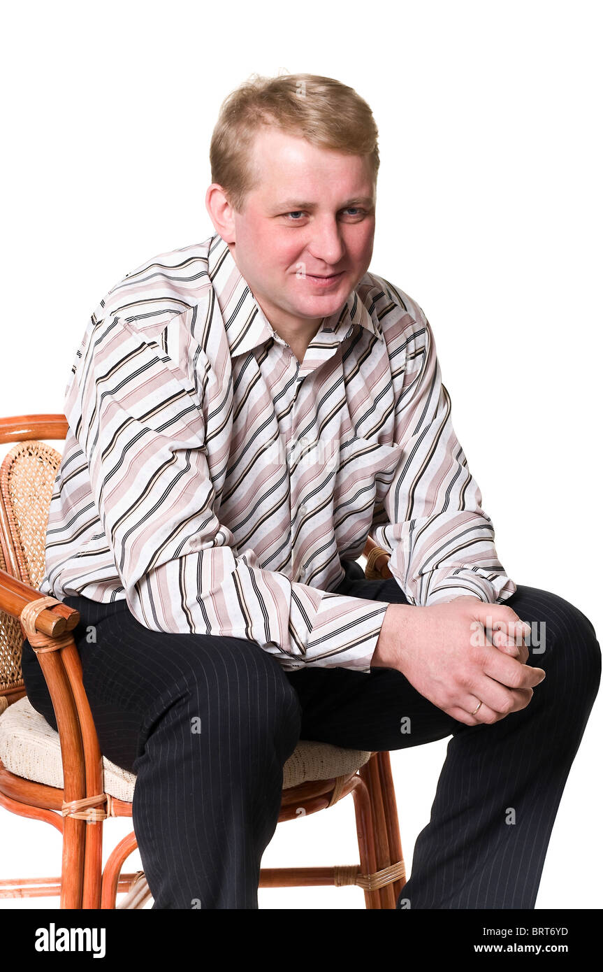 Portrait of middle age imposing man who is sitting in armchair and ...