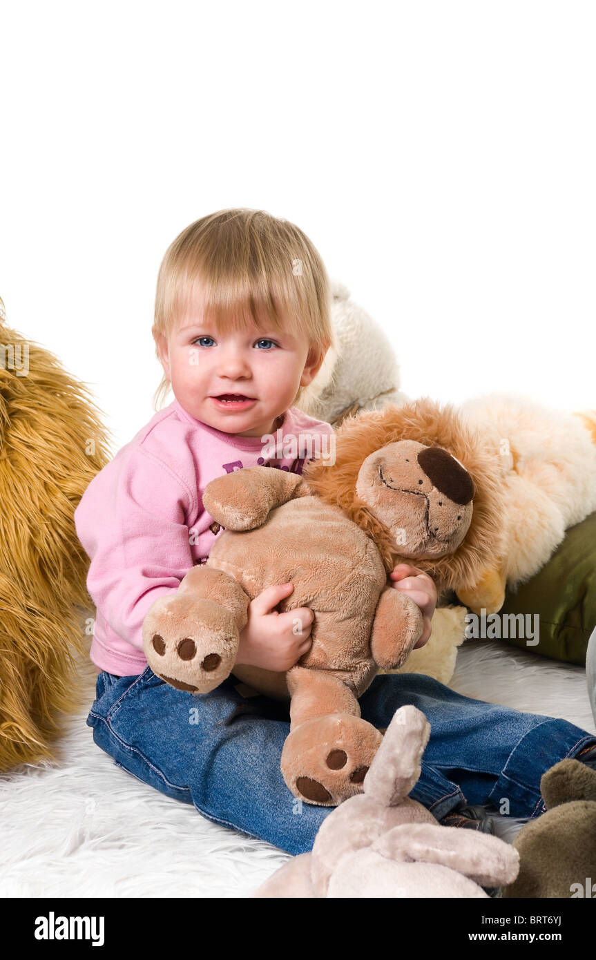 Little child playing on floor with toy Stock Photo - Alamy