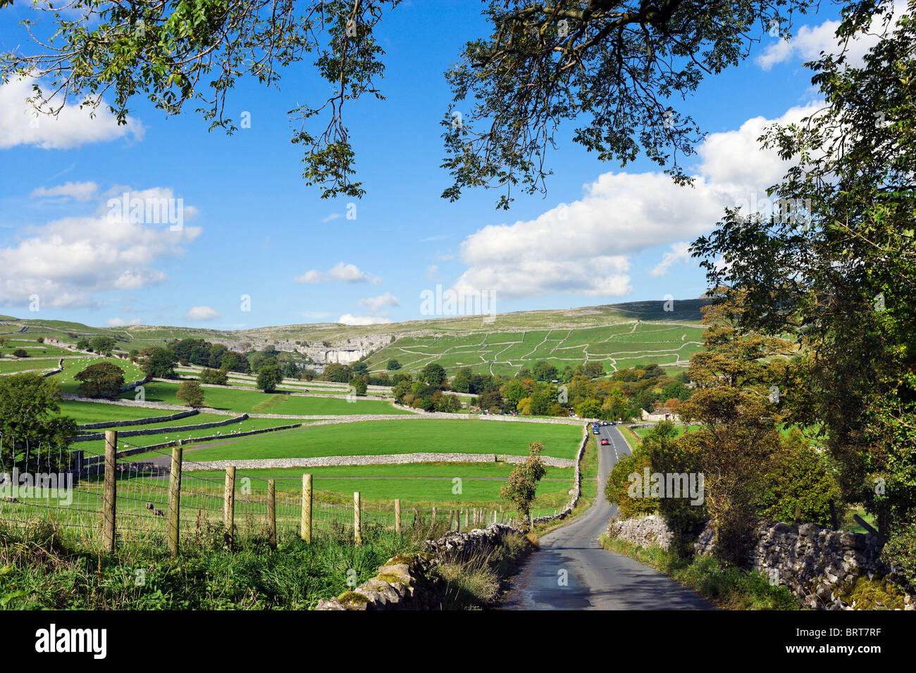 Country road leading to Malham and with Malham Cove in the distance ...
