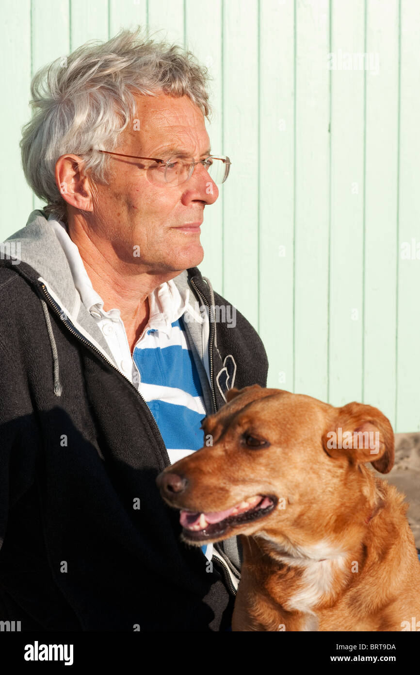 Elderly man with his dog by sunset outdoor Stock Photo - Alamy