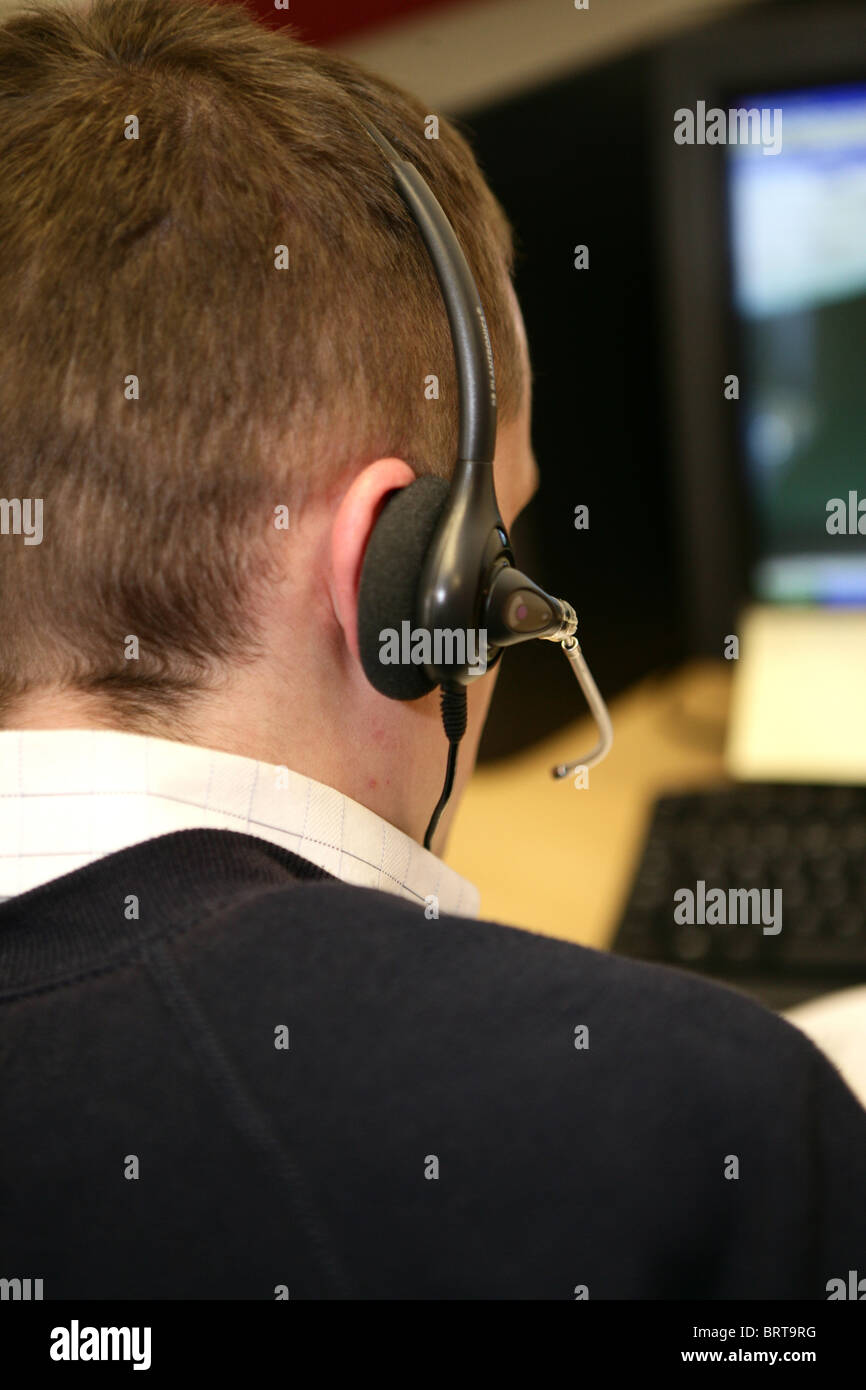 Office worker wearing headphones Stock Photo - Alamy