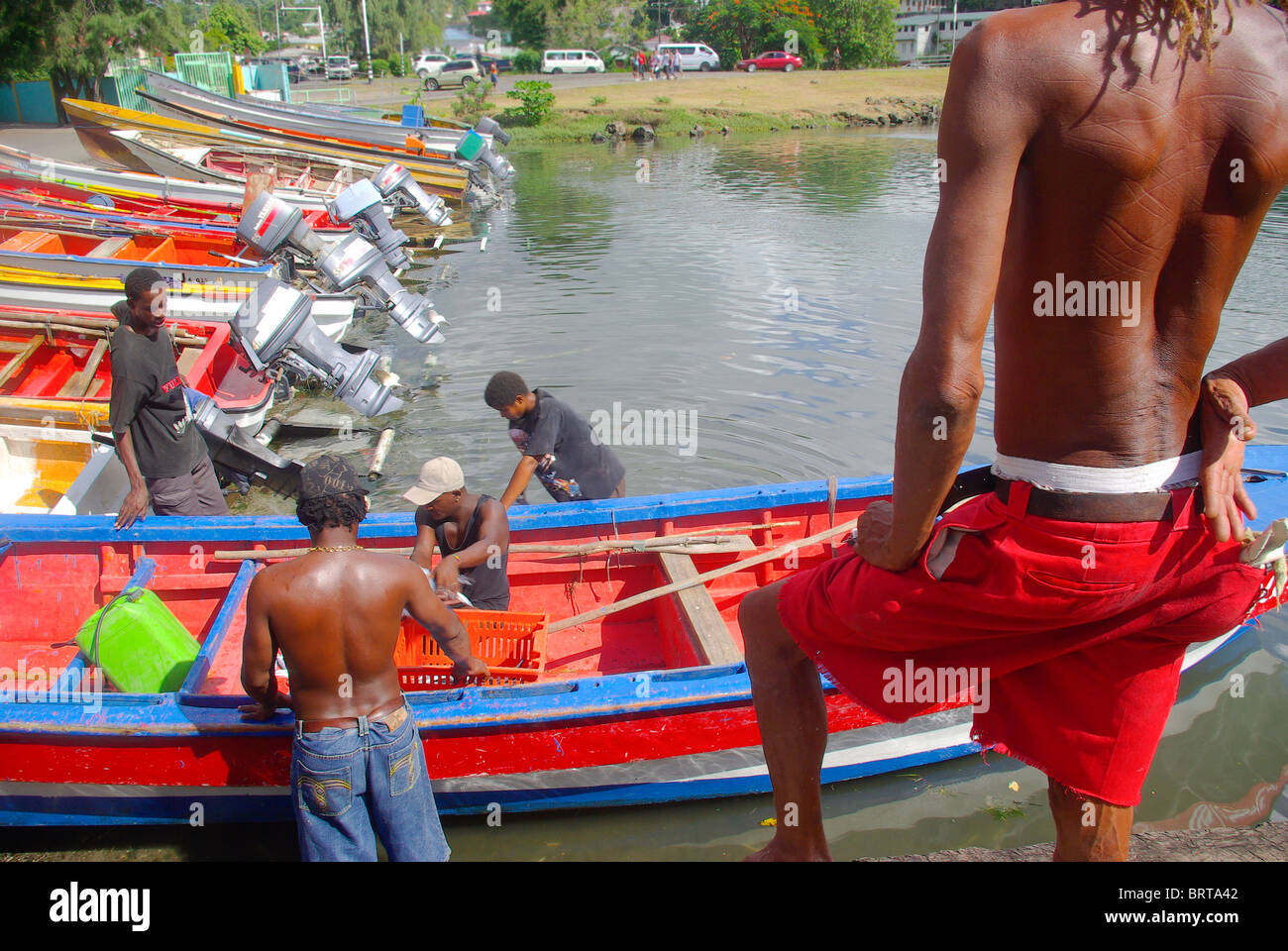Fishermen pulling boat to shore at Castries fishing complex Saint Lucia ...