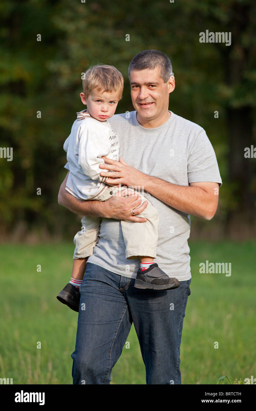 a father holding his young son in his arms Stock Photo - Alamy