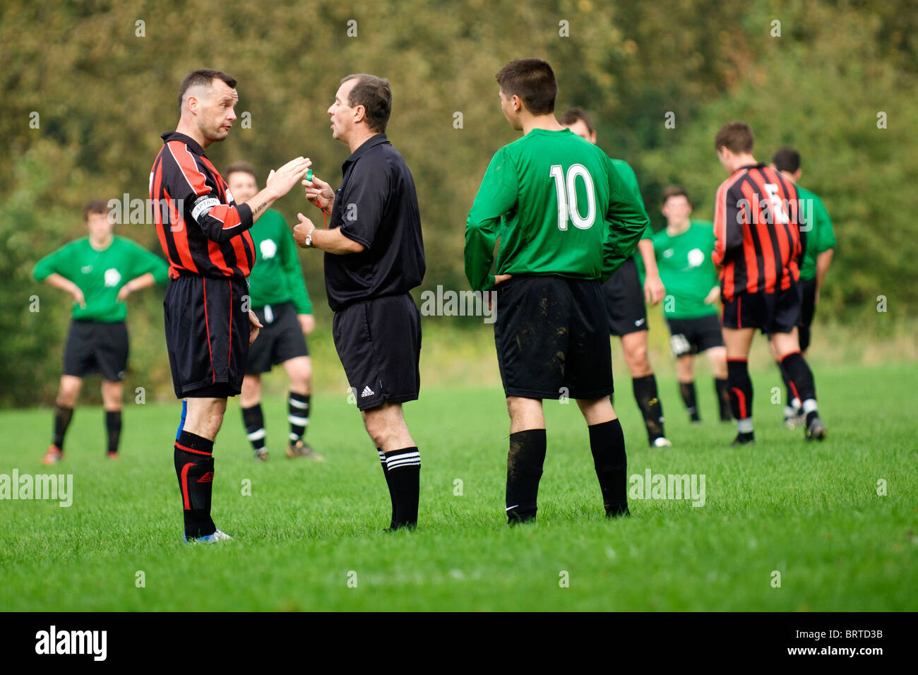 referee reprimands the captain of a football team Stock Photo - Alamy
