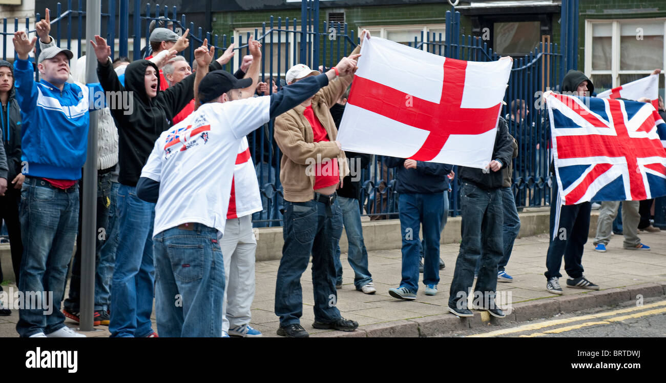 Proud EDL members hold flags as The English Defence League demonstrate ...