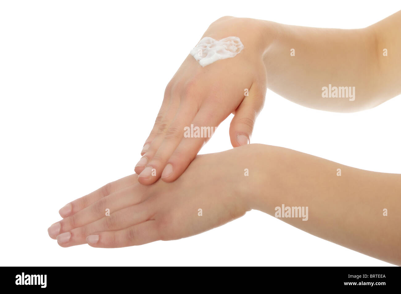 Closeup of beautiful female hands applying hand cream isolated on white ...