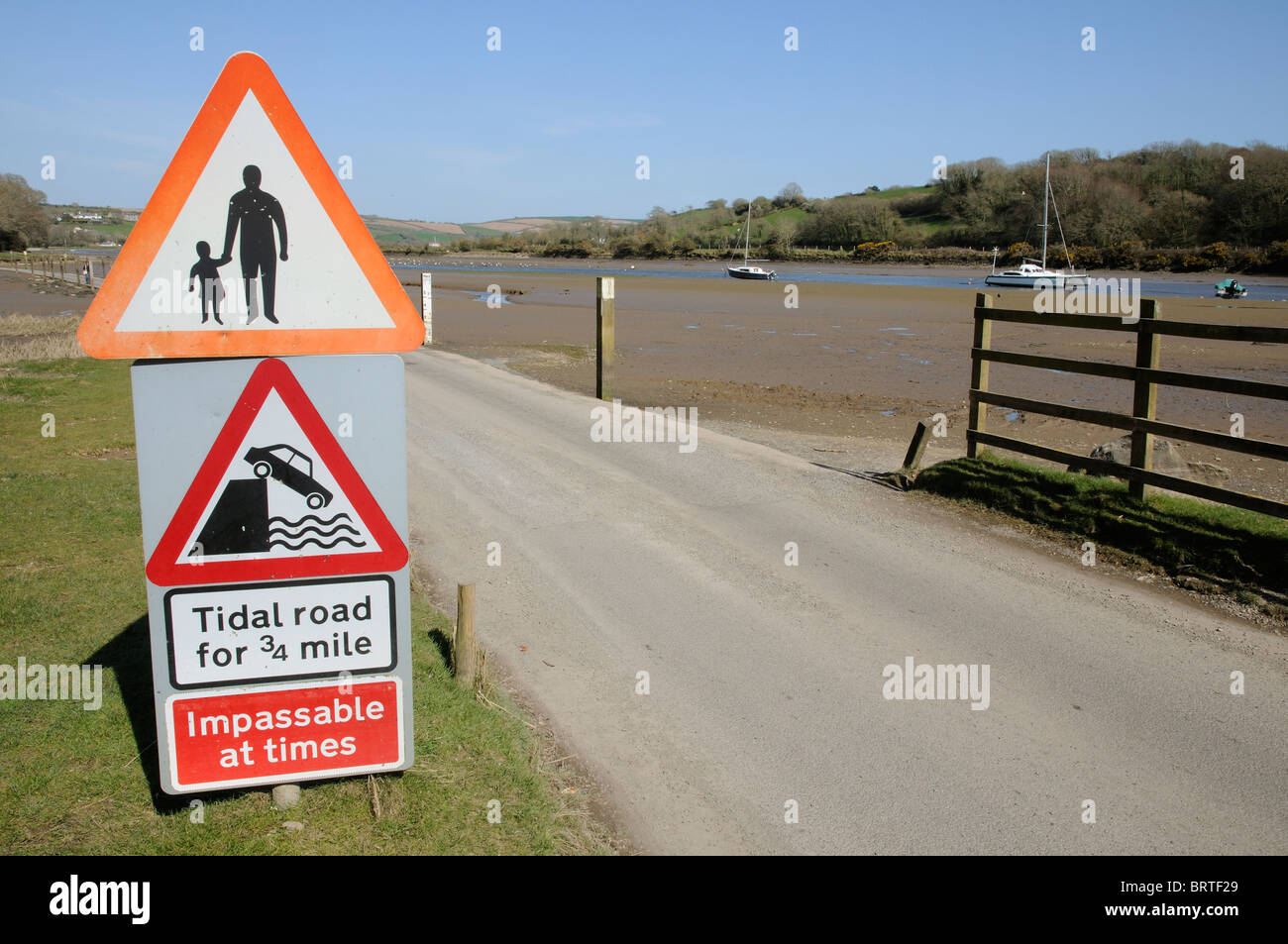 Tidal road and warning signs alongside the River Avon between Bigbury ...