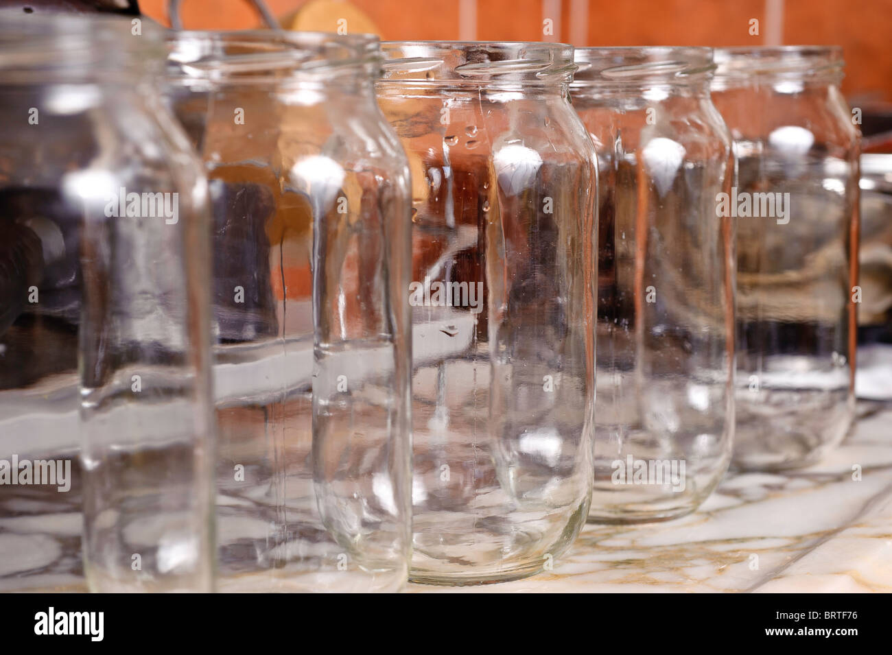 Five empty glass jars lined up on a kitchen marble work top Stock Photo ...