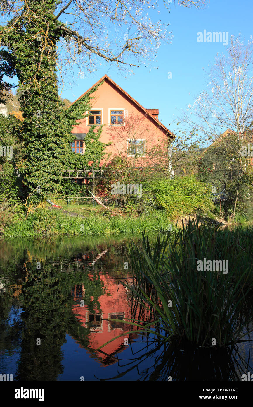 red house refllected in the river Naab at the village Kallmuenz,Upper ...