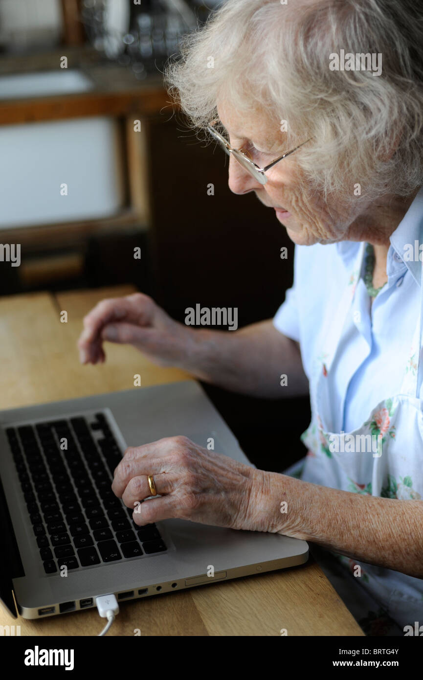 Older lady using laptop computer and learning about technology Stock ...
