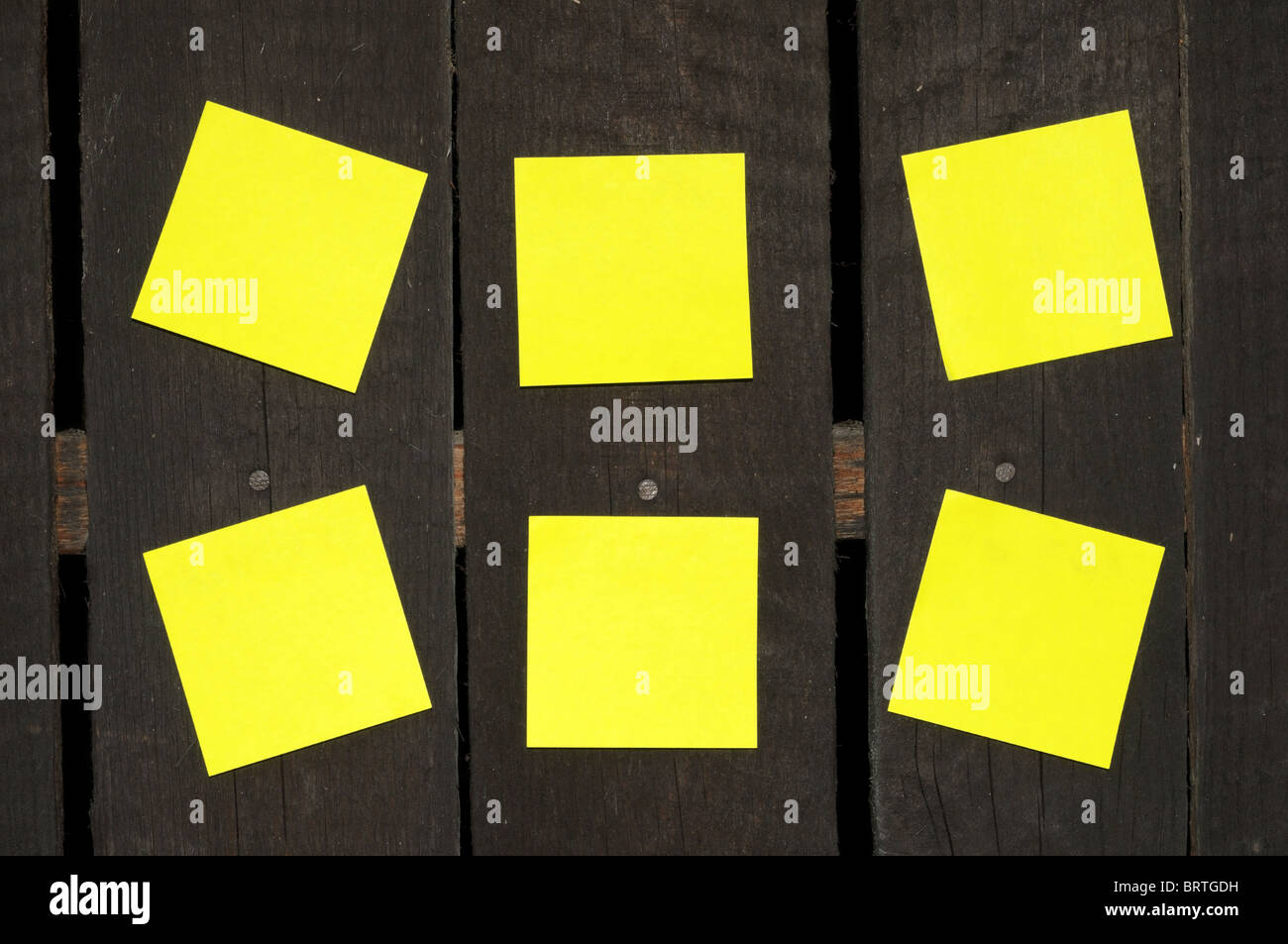 Yellow sticky notes on a wooden wall Stock Photo - Alamy