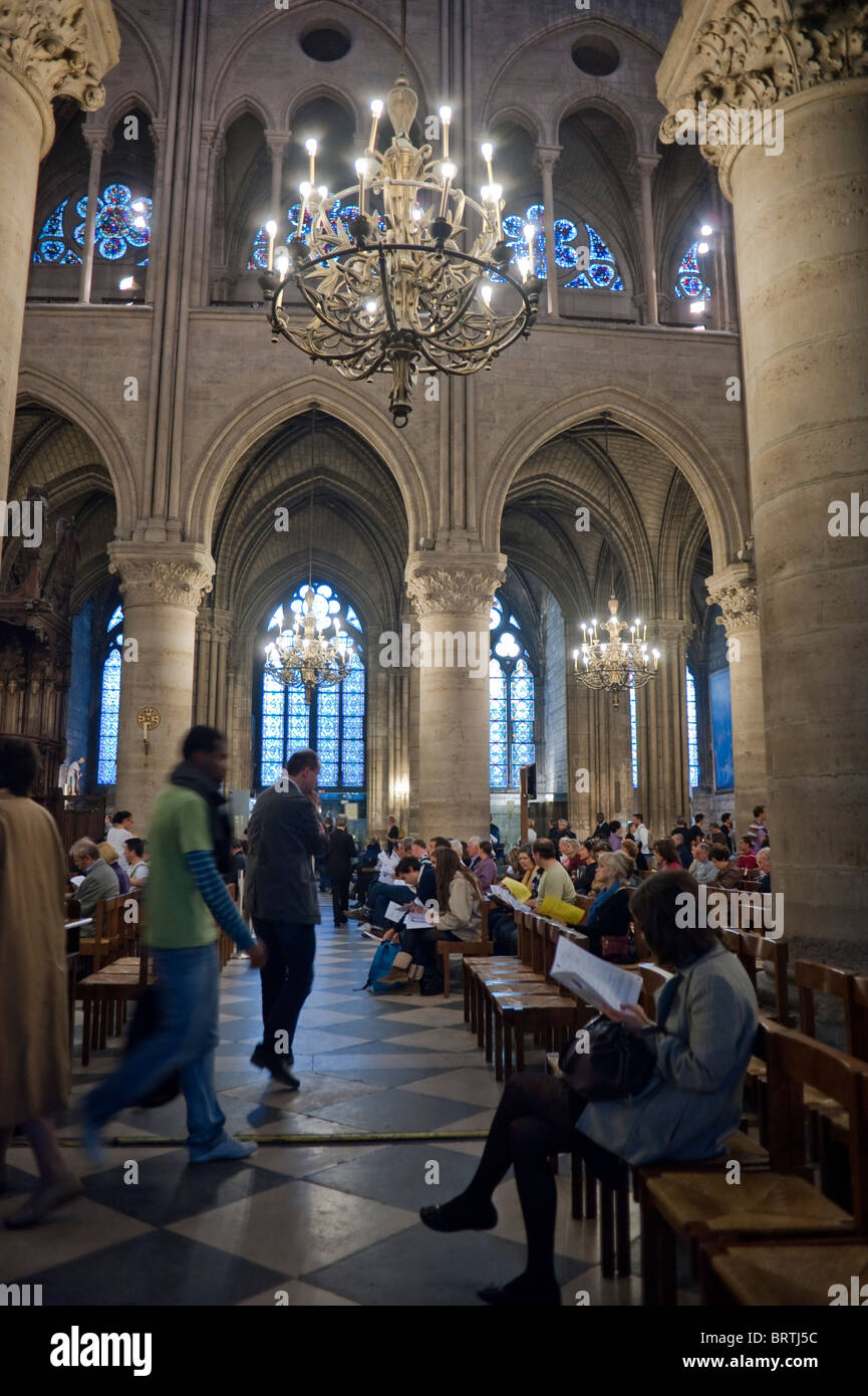 Paris, France - Large Crowd People praying at traditional catholic mass ...