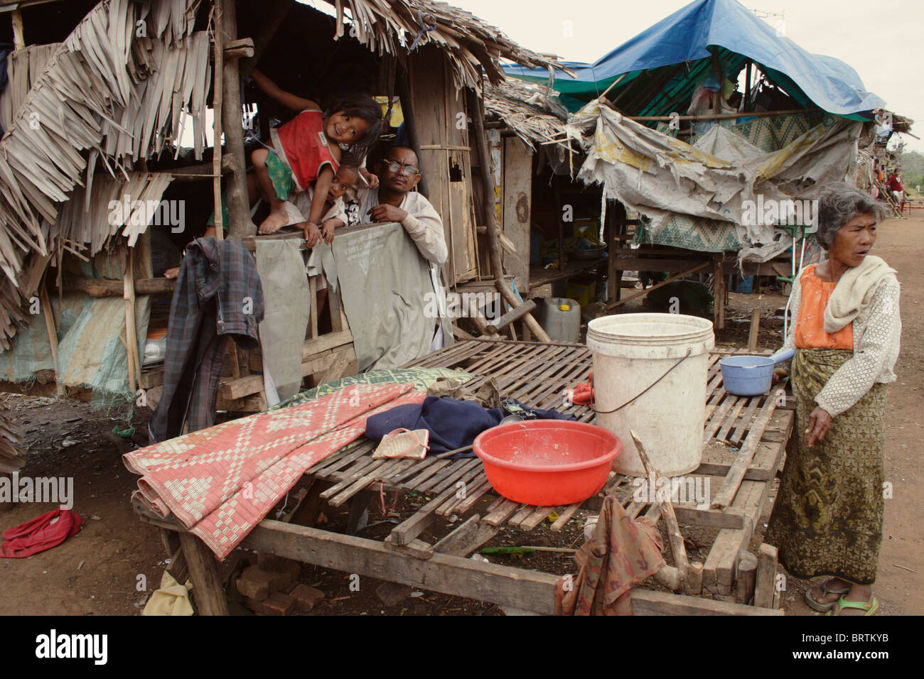 People living in poverty in a squatter's slum are tending to daily ...