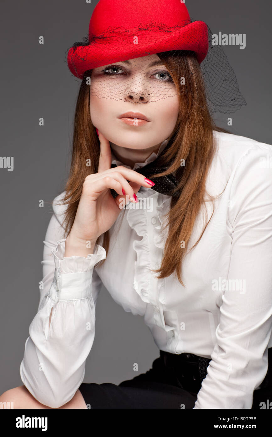 Portrait of a pretty young woman with red bonnet Stock Photo - Alamy