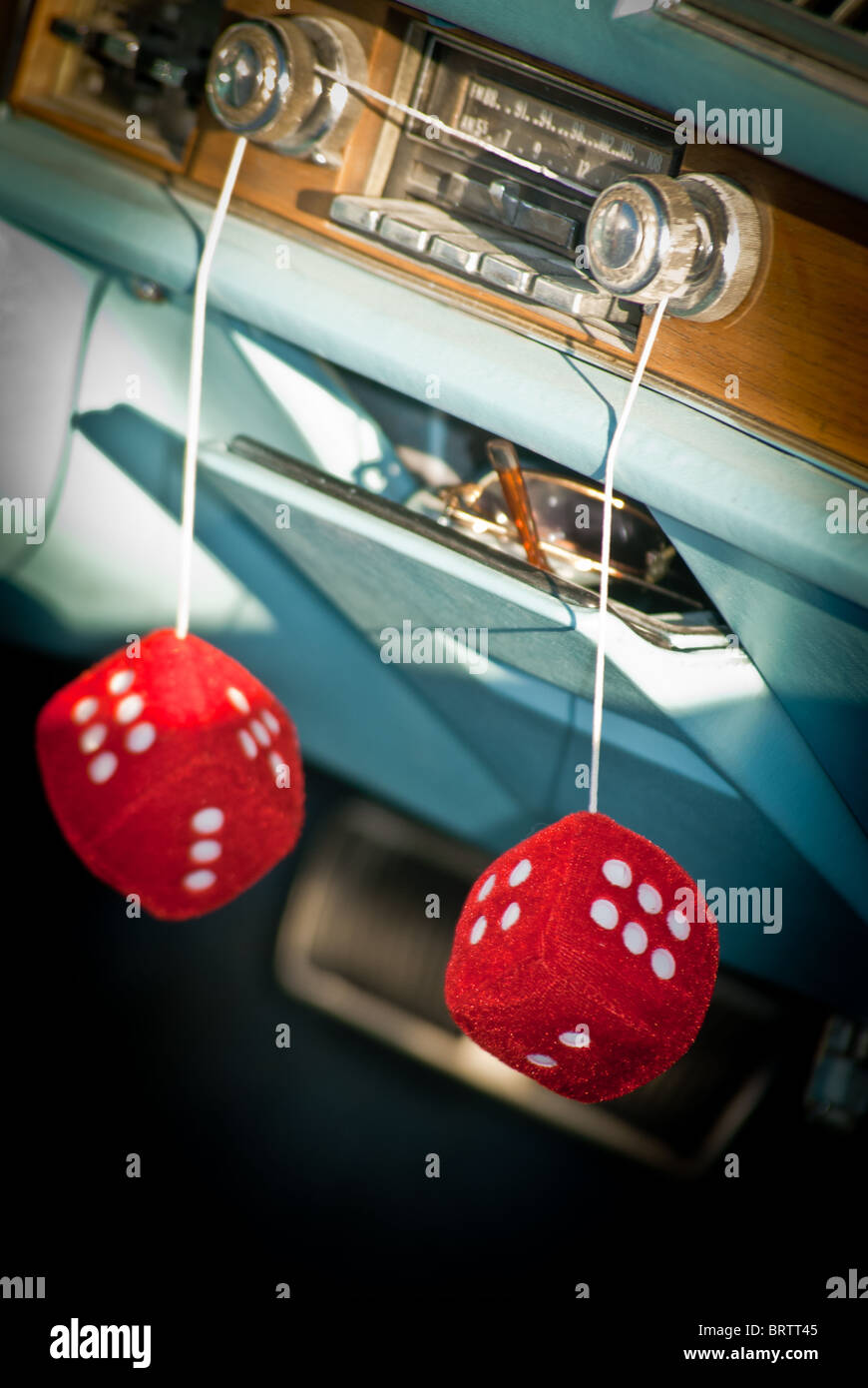 Furry dice on dashboard of American car Stock Photo - Alamy
