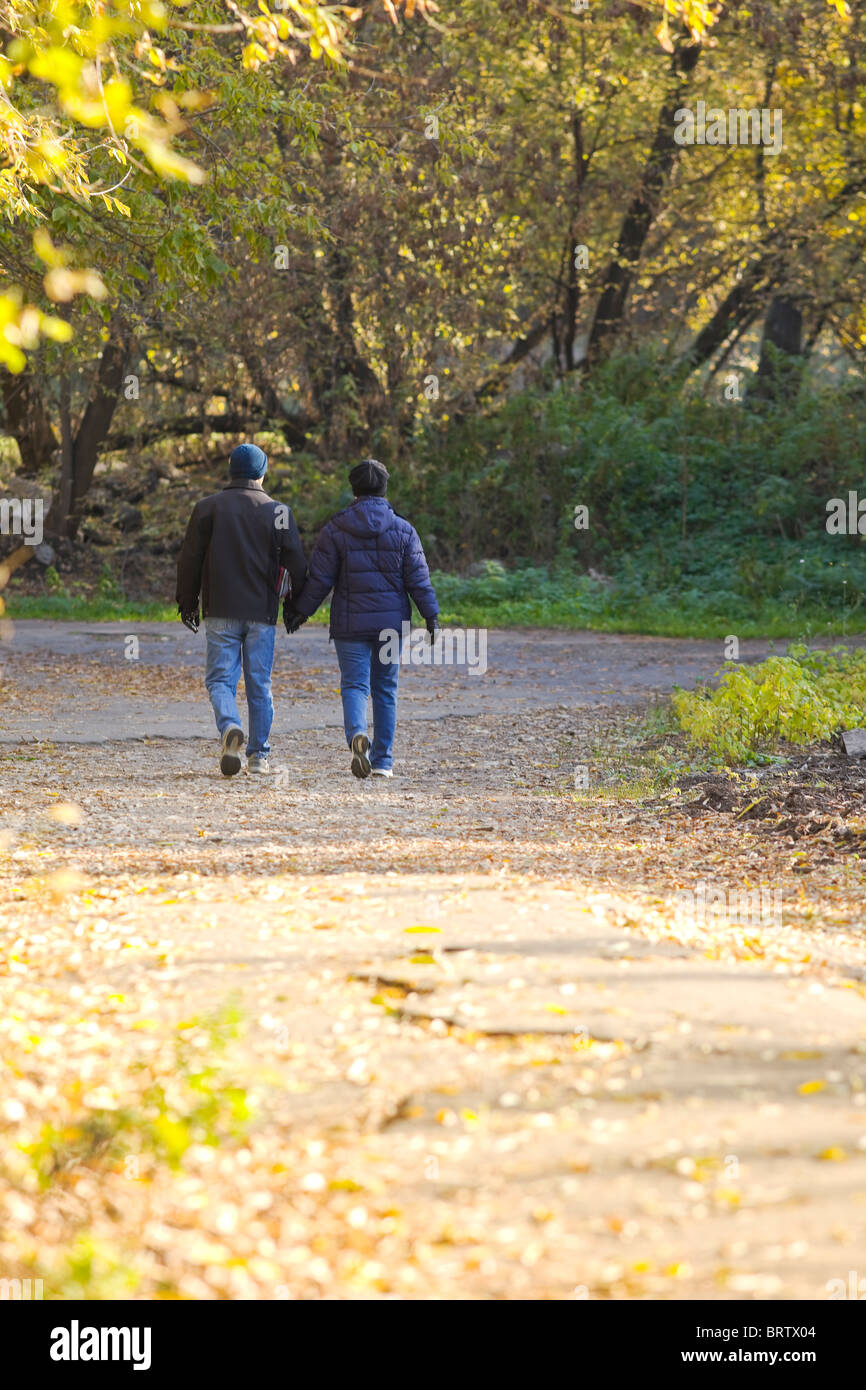 couple walk in autumn park Stock Photo - Alamy