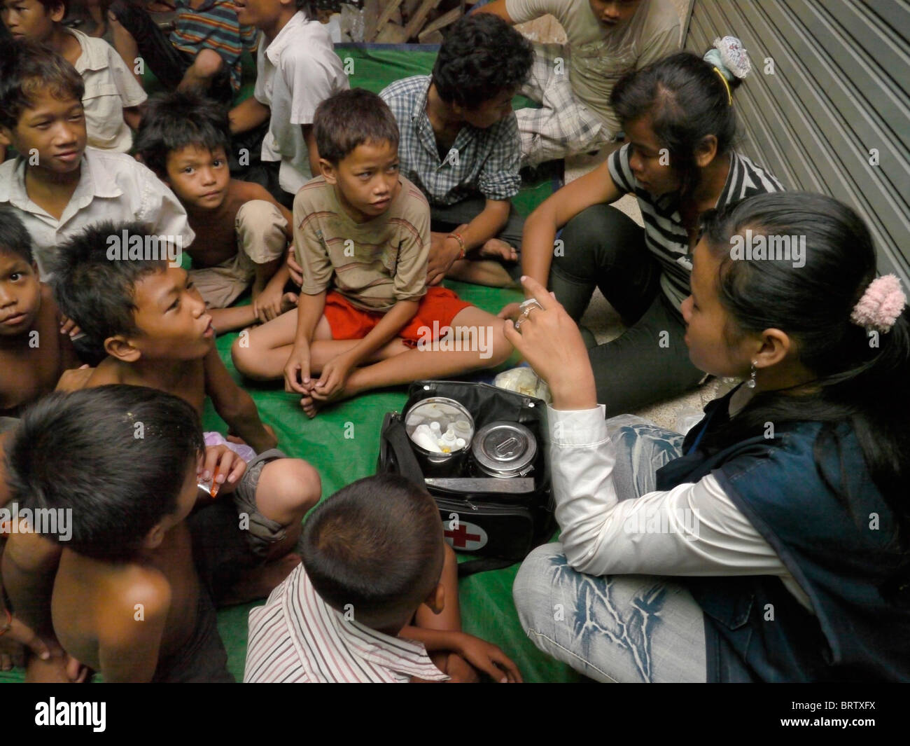 CAMBODIA Children receiving first aid by an outreach team of CSARO ...