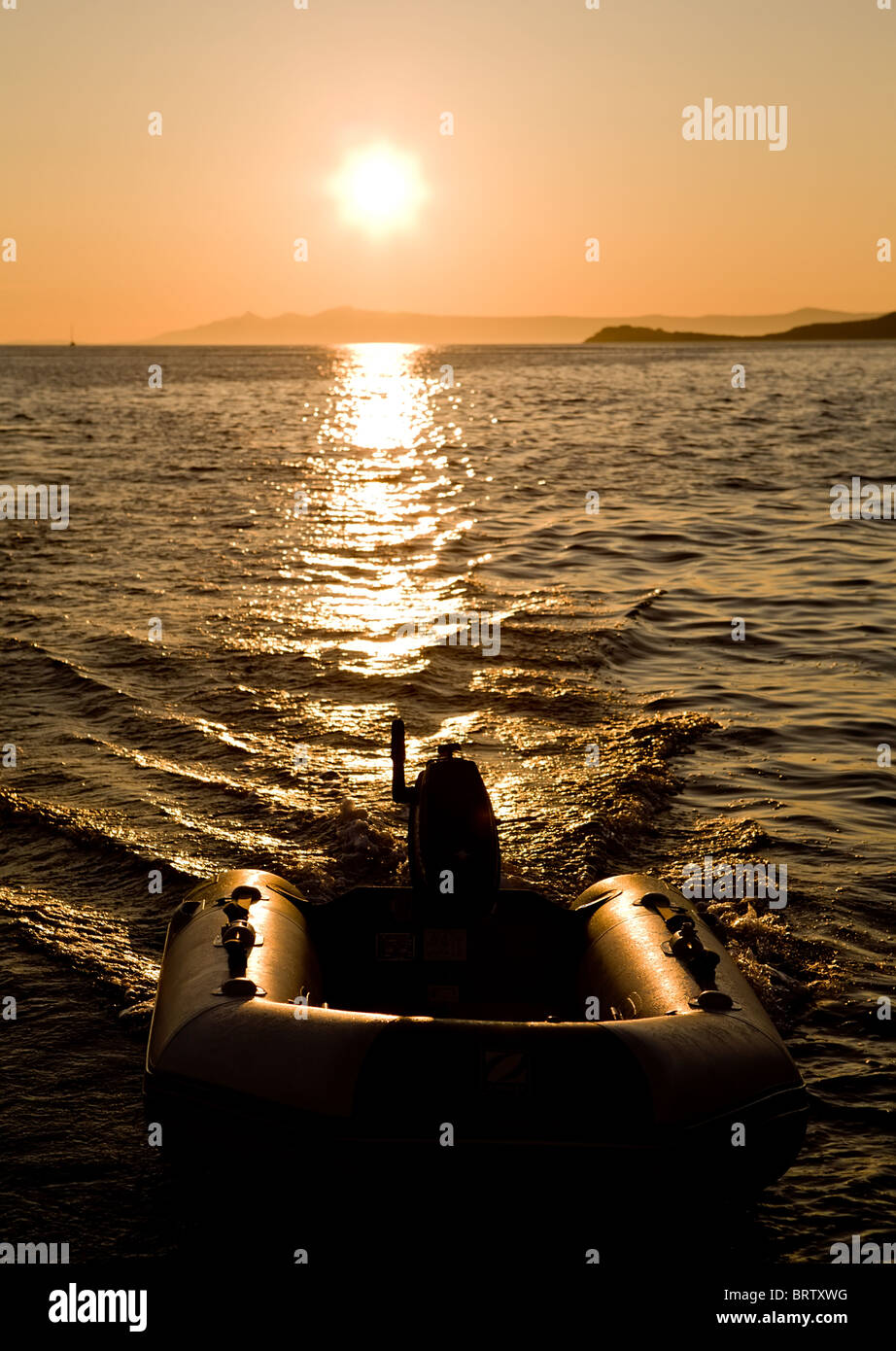 rubber boat on sunset seascape background Stock Photo - Alamy