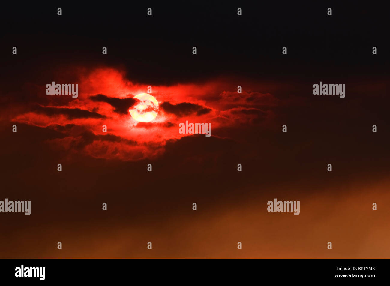 Close up of Stunning fiery red sunset taken at the Loch Shin mountain ...