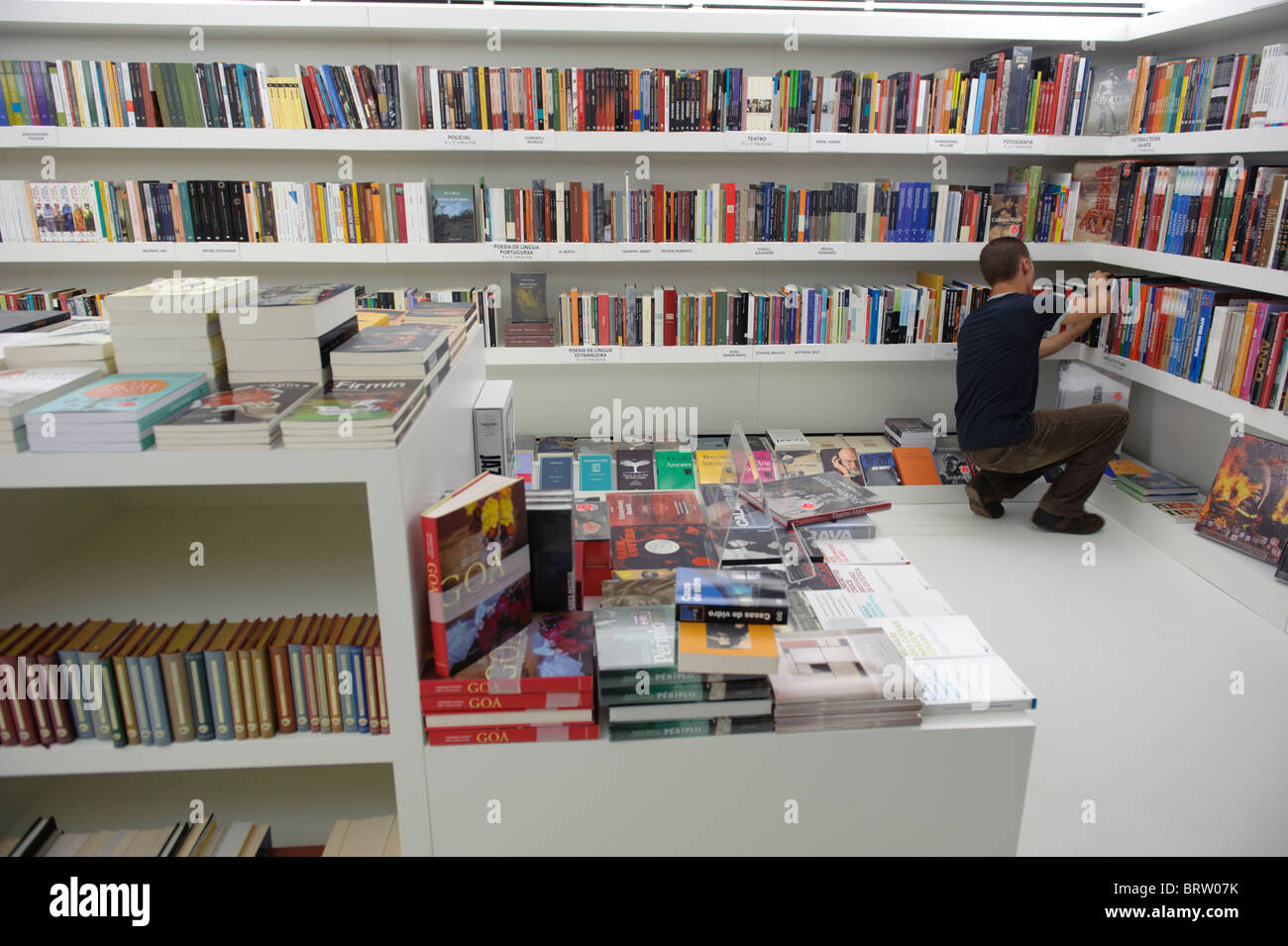Man looking at books in bookstore Stock Photo - Alamy