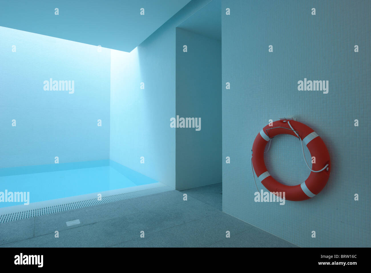 Empty small indoor swimming pool in blue with red life saver Stock ...