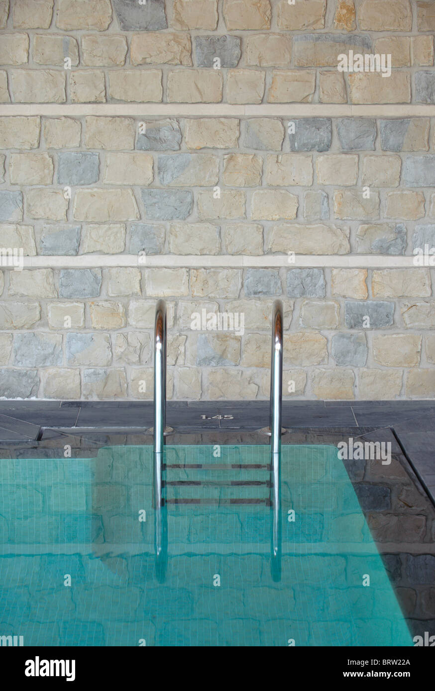 Indoor swimming pool entry ladder Stock Photo - Alamy