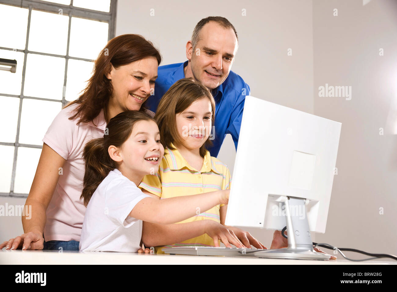 Family in front of a computer together Stock Photo - Alamy