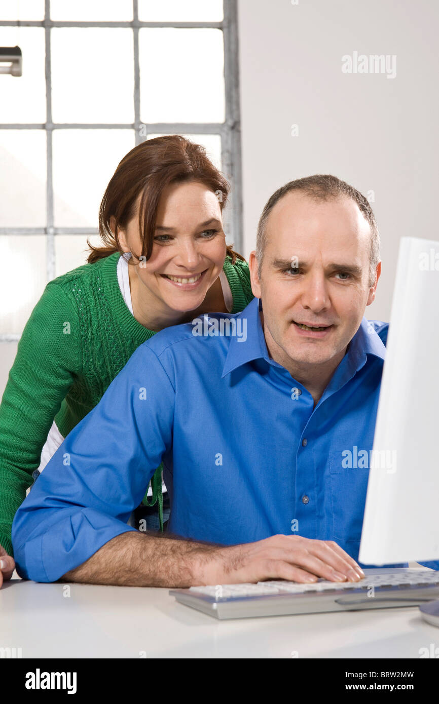 Woman and man together at a computer Stock Photo - Alamy