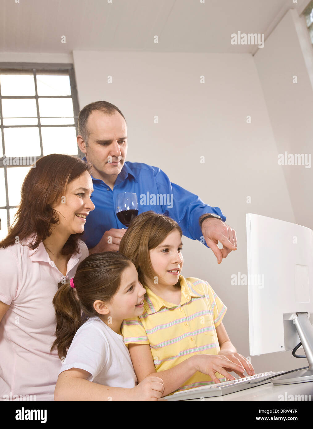 Family in front of a computer together Stock Photo - Alamy