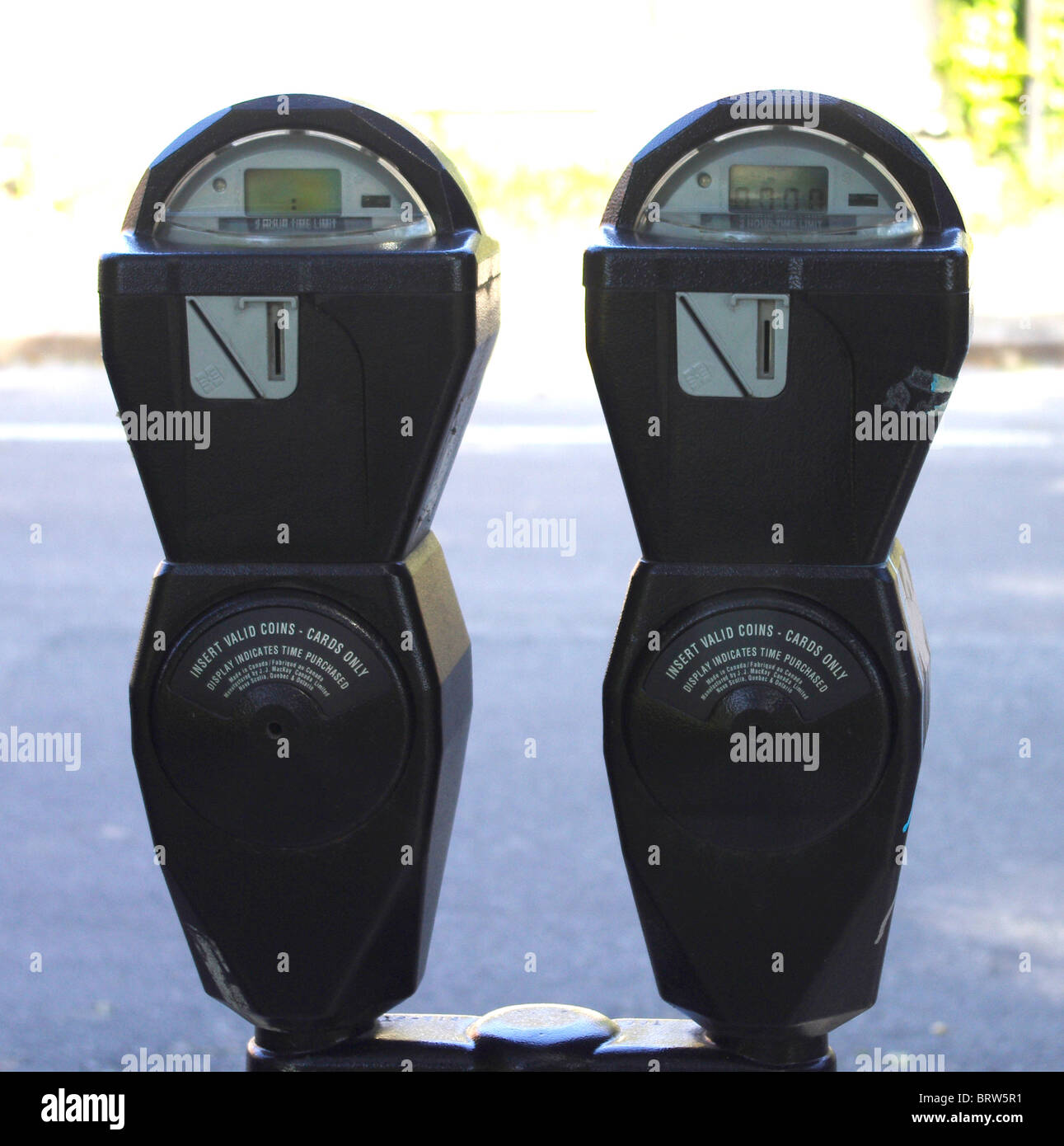 Pair of parking meters Stock Photo - Alamy