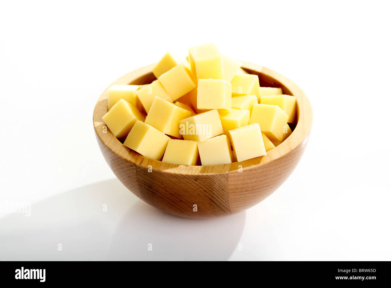 Diced cheese in a wooden bowl Stock Photo - Alamy