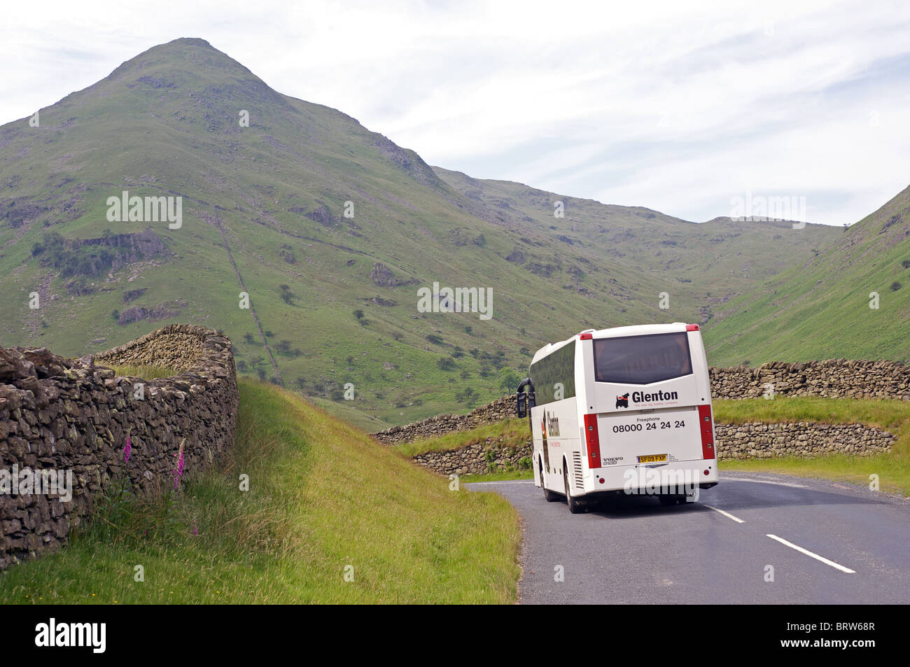 Tourist coach traveling on the A592 (Kirkstone Pass) mountain road ...