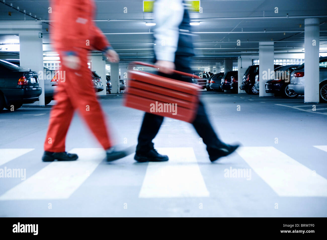 Workmen on a zebra-crossing in an underground carpark Stock Photo - Alamy