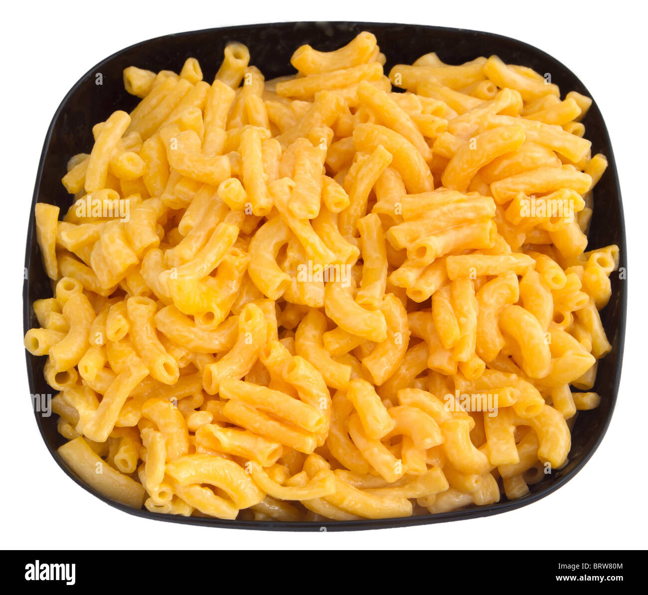 macaroni and cheese dinner on a yellow plate isolated over white Stock ...