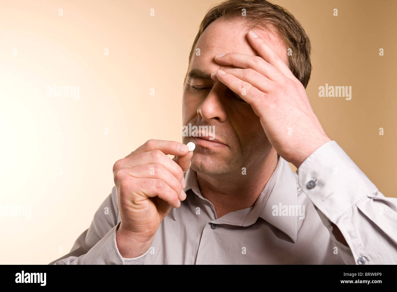 Man taking a tablet Stock Photo - Alamy