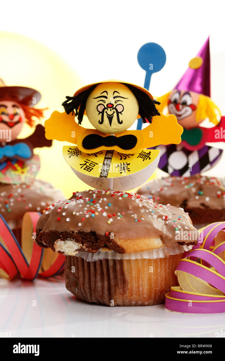 Chocolate-coated muffins with decorative paper figurines Stock Photo ...