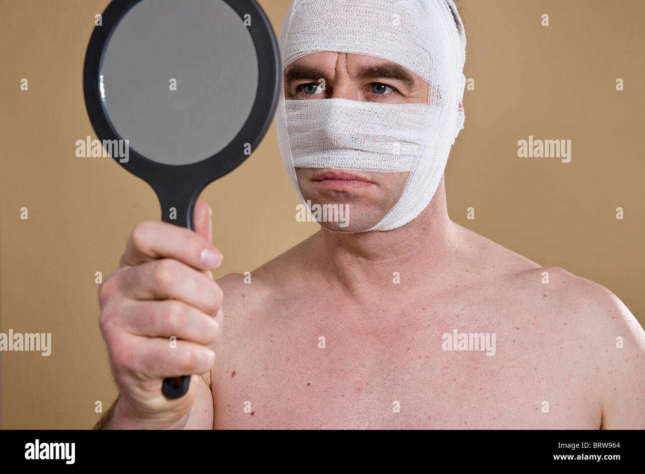 Man checking face bandage hi-res stock photography and images - Alamy