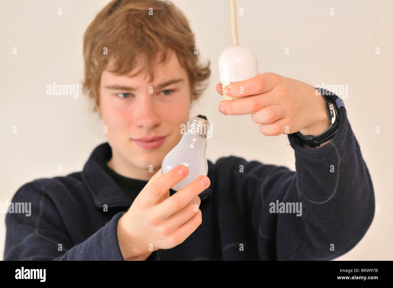 Man changes light bulb hi-res stock photography and images - Alamy
